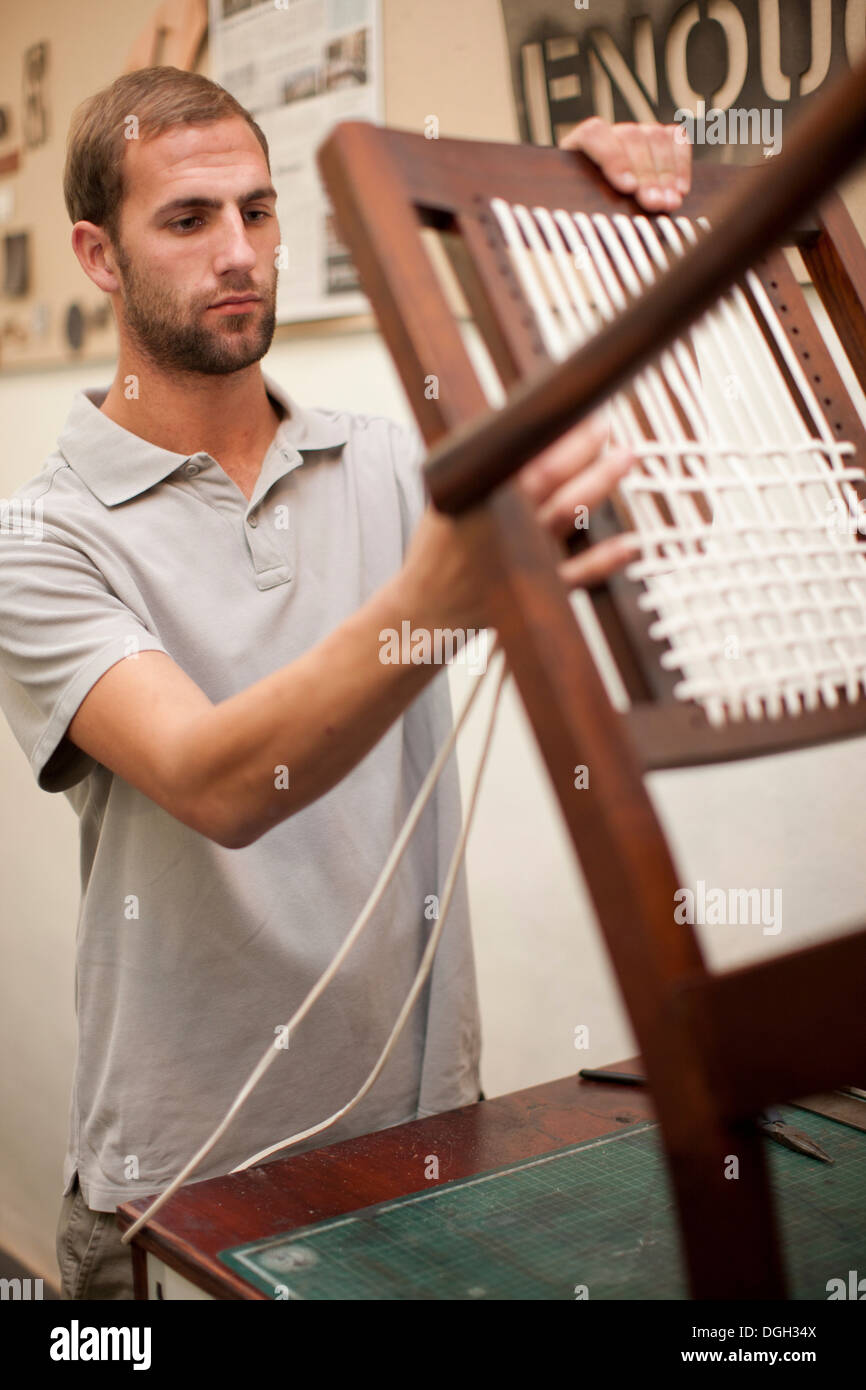 Man weaving chair back Stock Photo - Alamy