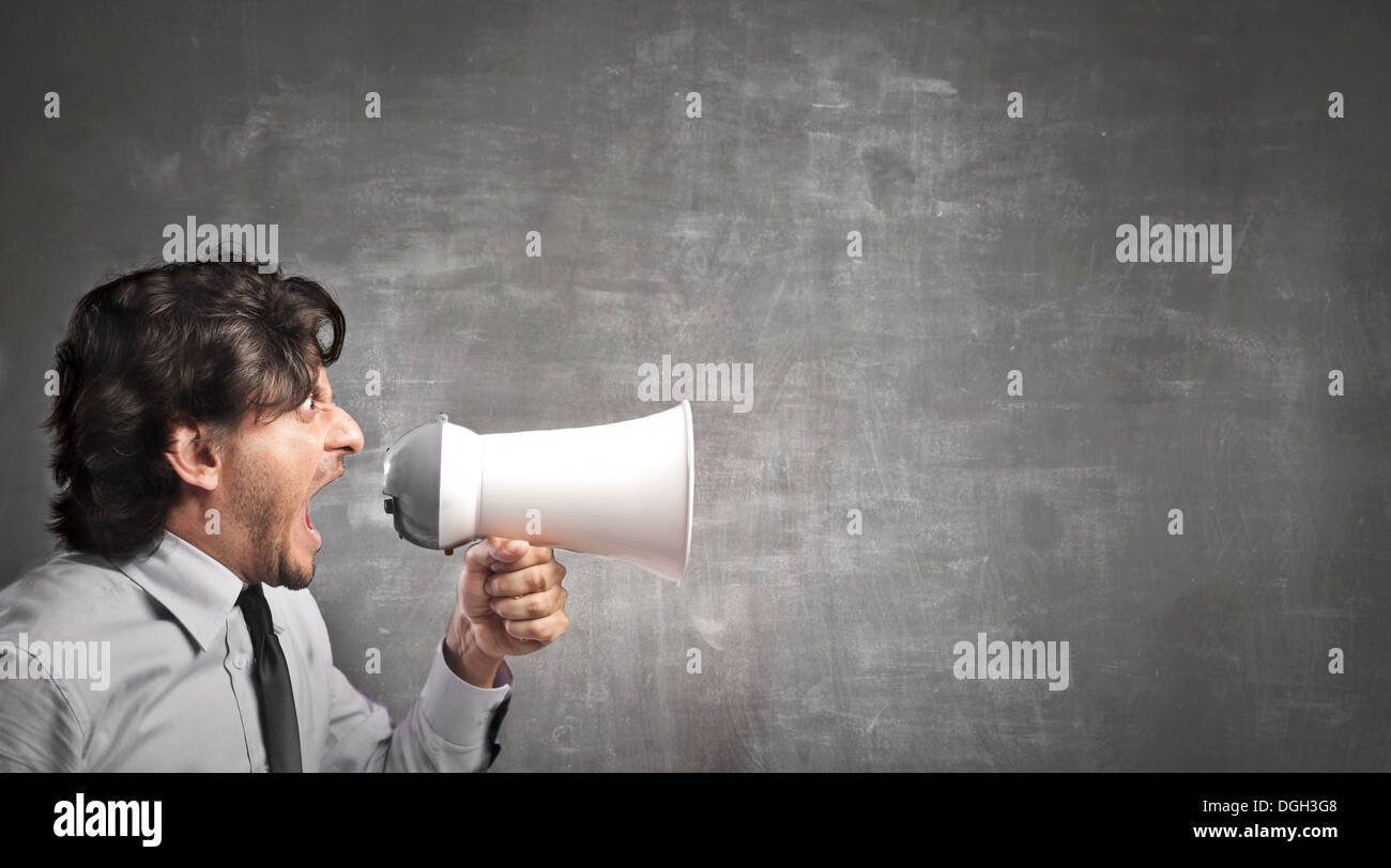 Office worker screaming through a megaphone Stock Photo - Alamy