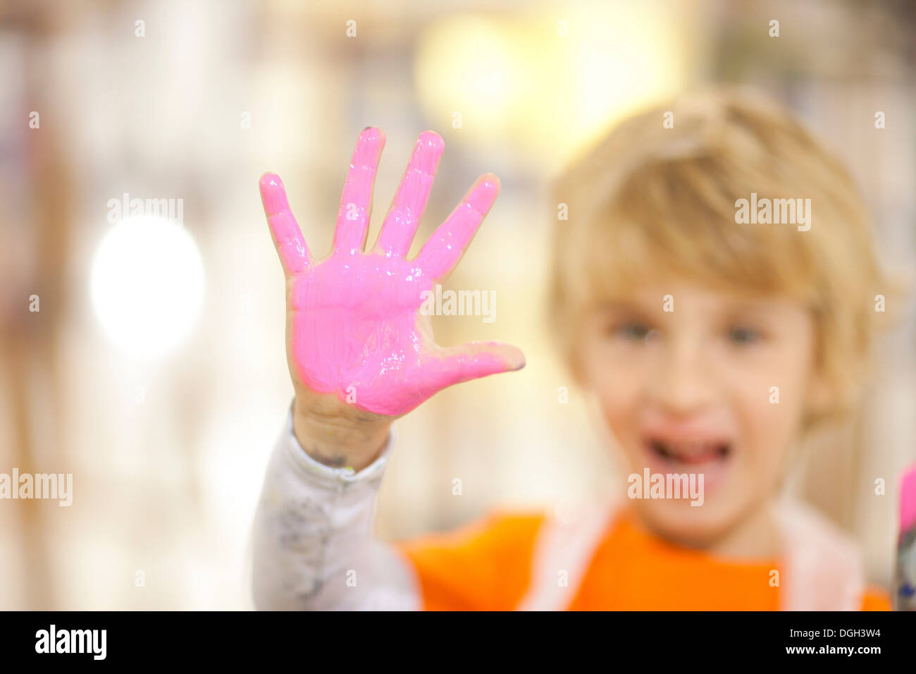 Boy with pink paint on his hand Stock Photo - Alamy