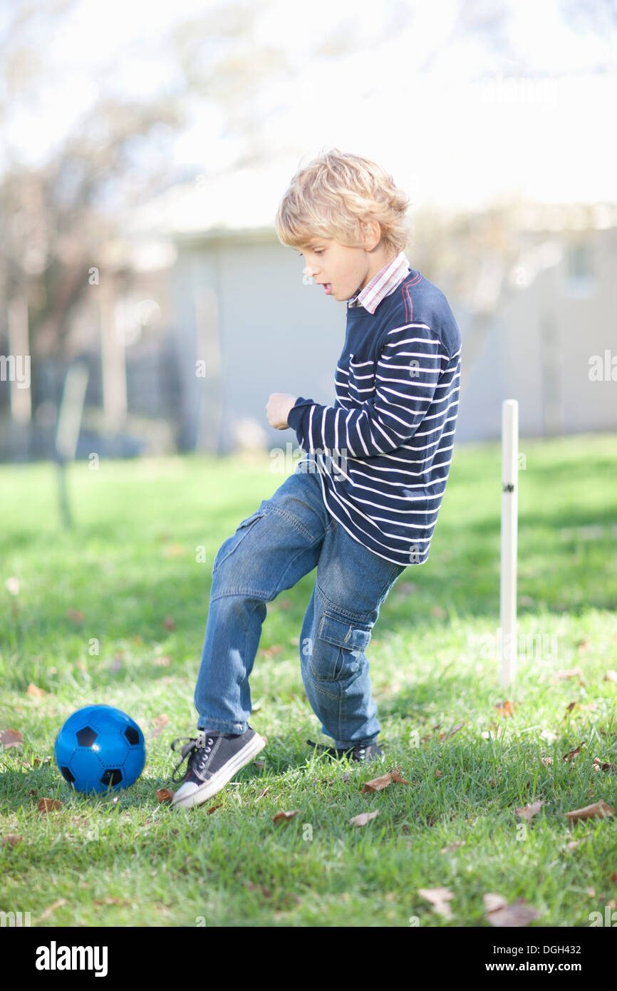 Boy playing football Stock Photo - Alamy