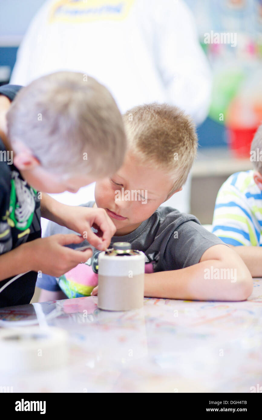 Boys making craft object Stock Photo - Alamy