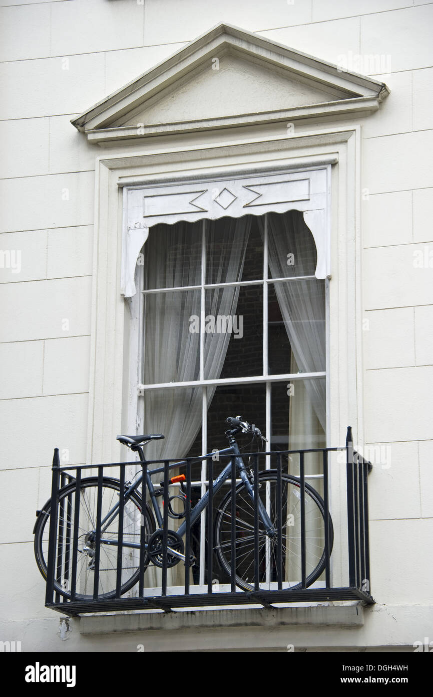 Bicycle on small balcony of city building, London, England, april Stock ...