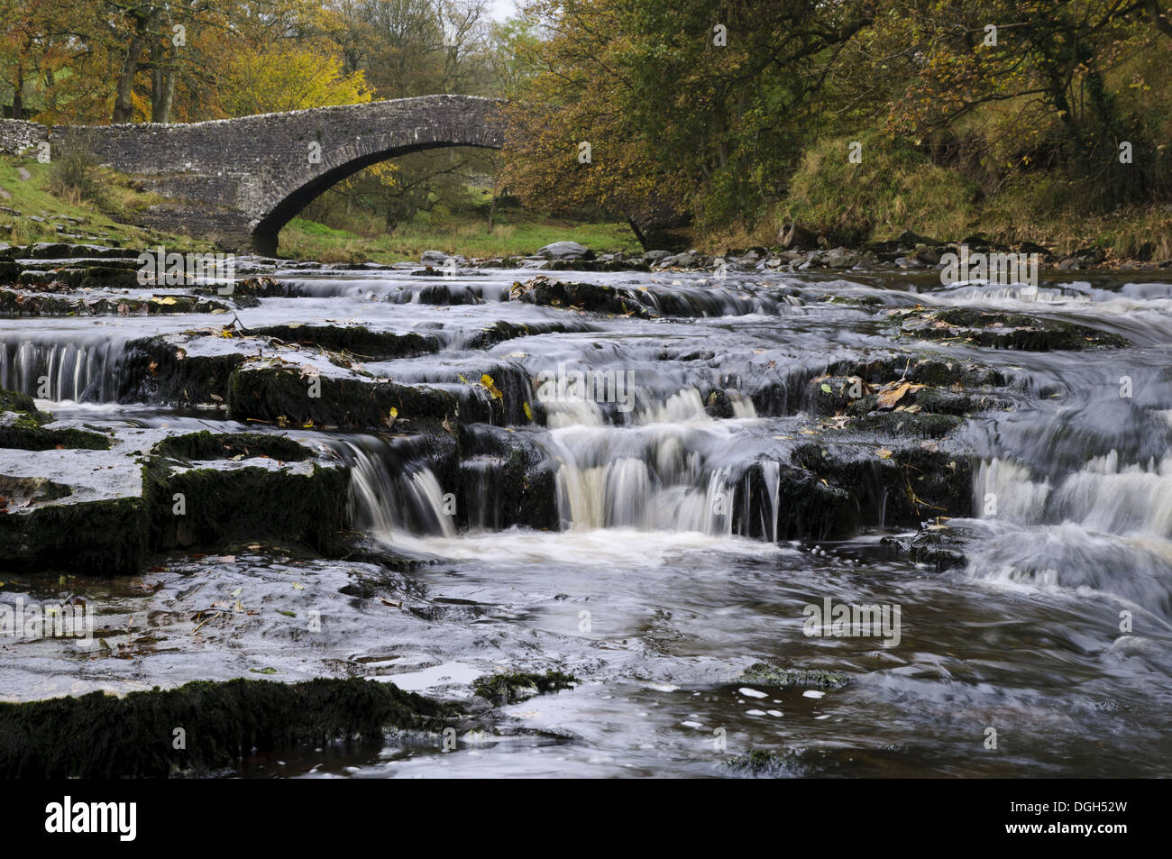 View of river cascades and old pack-horse bridge Stainforth Force River ...