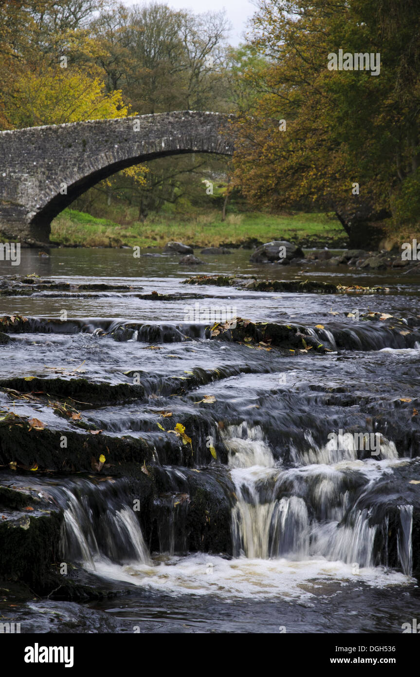 View of river cascades and old pack-horse bridge Stainforth Force River ...