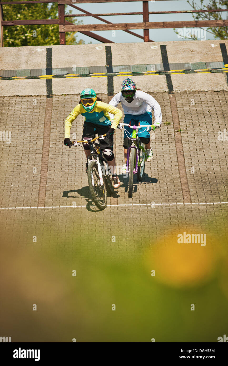 Cyclists riding on dirt bike course Stock Photo - Alamy