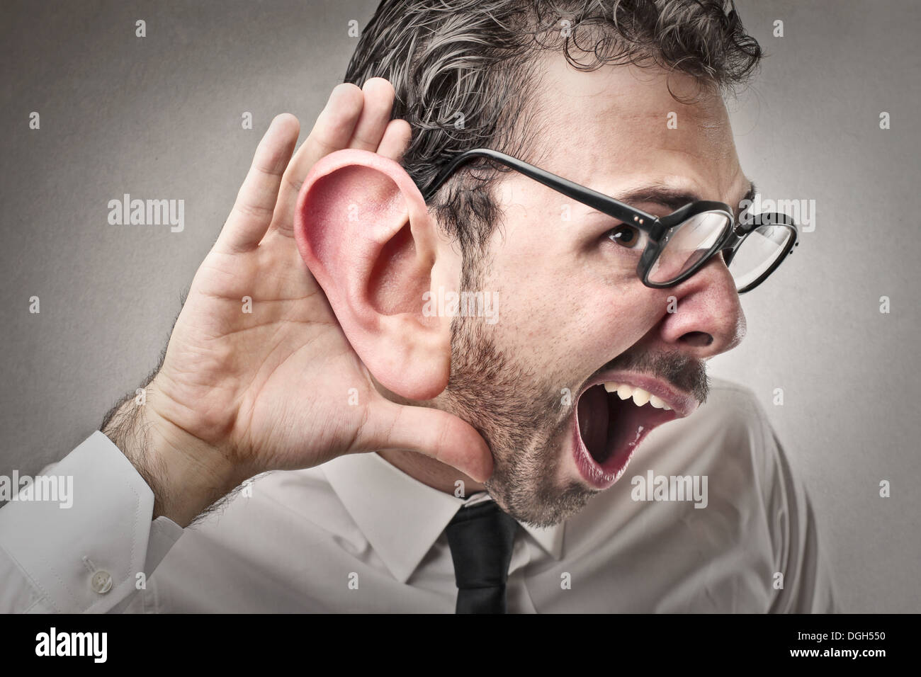 Office worker with a giant ear can't not hear someone Stock Photo - Alamy
