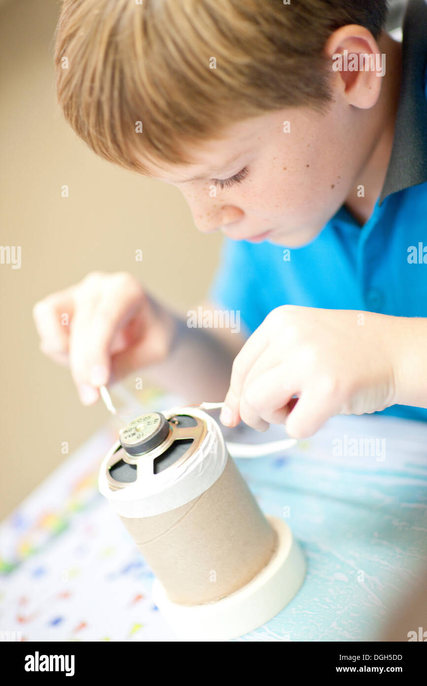 Boy making craft object Stock Photo - Alamy