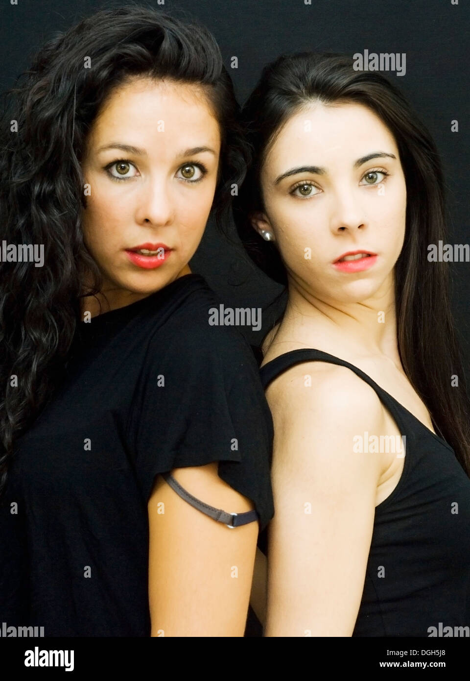 Two beautiful friends back to each other Stock Photo - Alamy