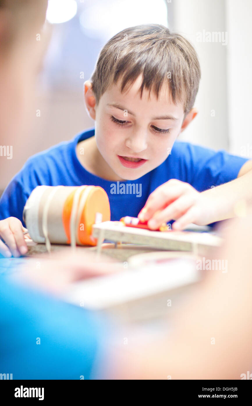 Boy making craft object Stock Photo - Alamy