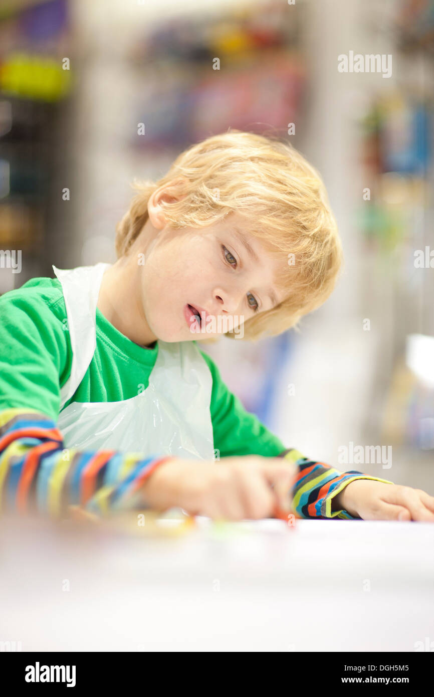 Boy concentrating on drawing Stock Photo - Alamy