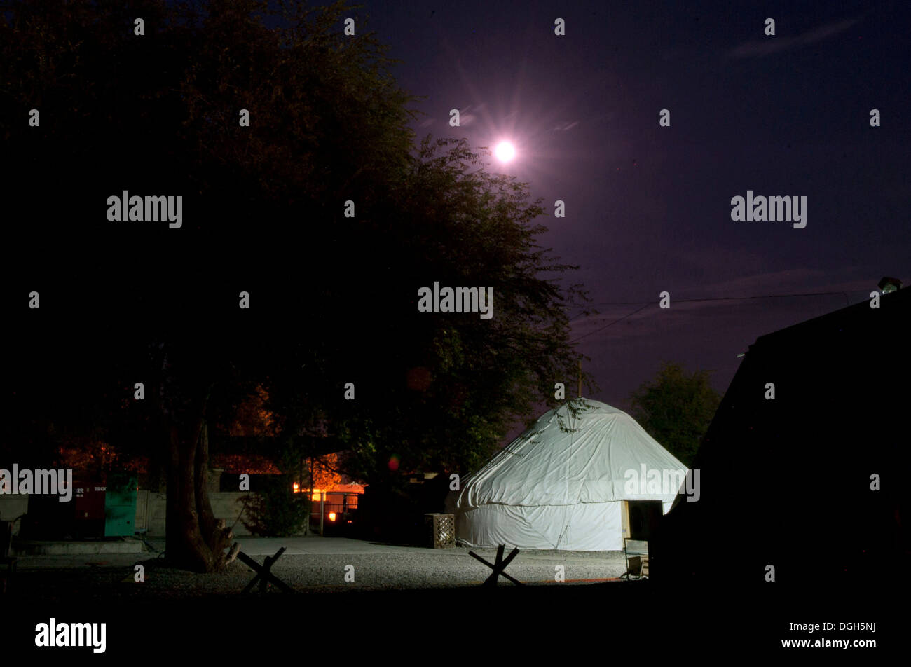 A yurt is lit by moon light and light from the 376th Expeditionary ...