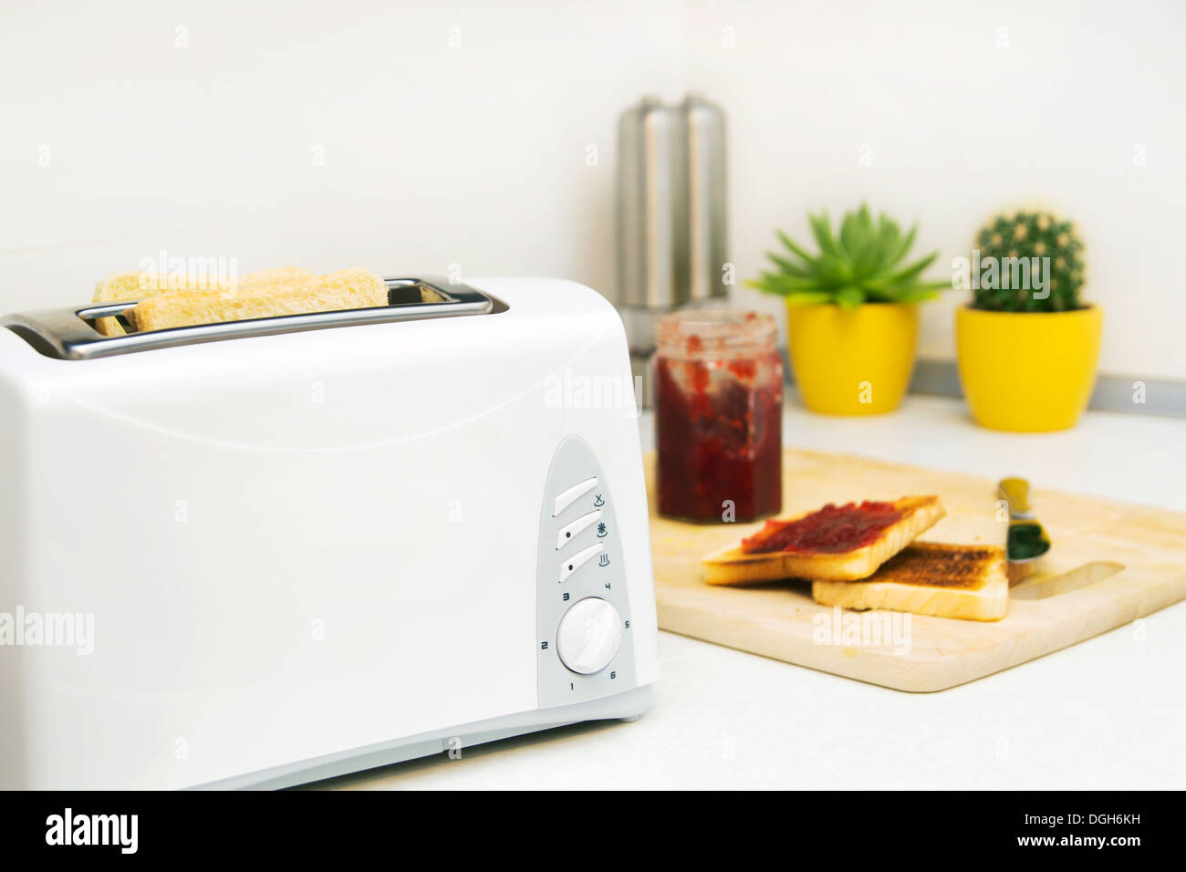 Breakfast prepare. Toaster and toast with jam in modern kitchen Stock ...