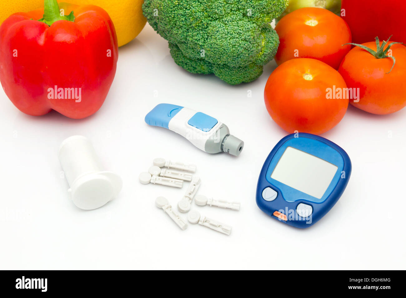 Glucose meter device with accessories. Vegetables and healthy lifestyle ...