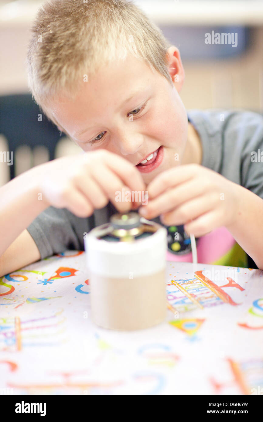 Boy making craft object Stock Photo - Alamy