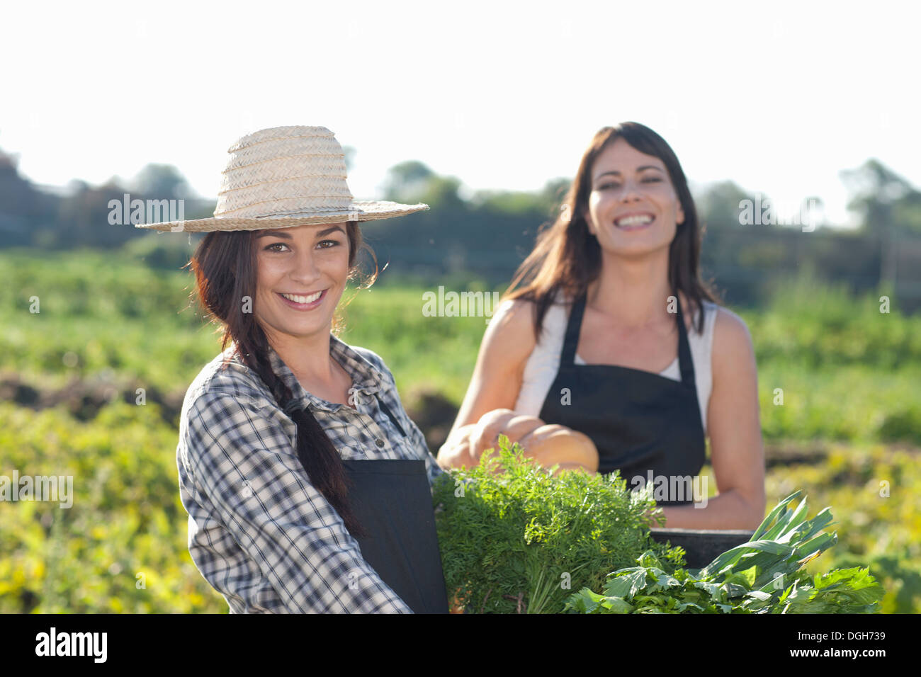 Women with vegetables grown at farm Stock Photo - Alamy