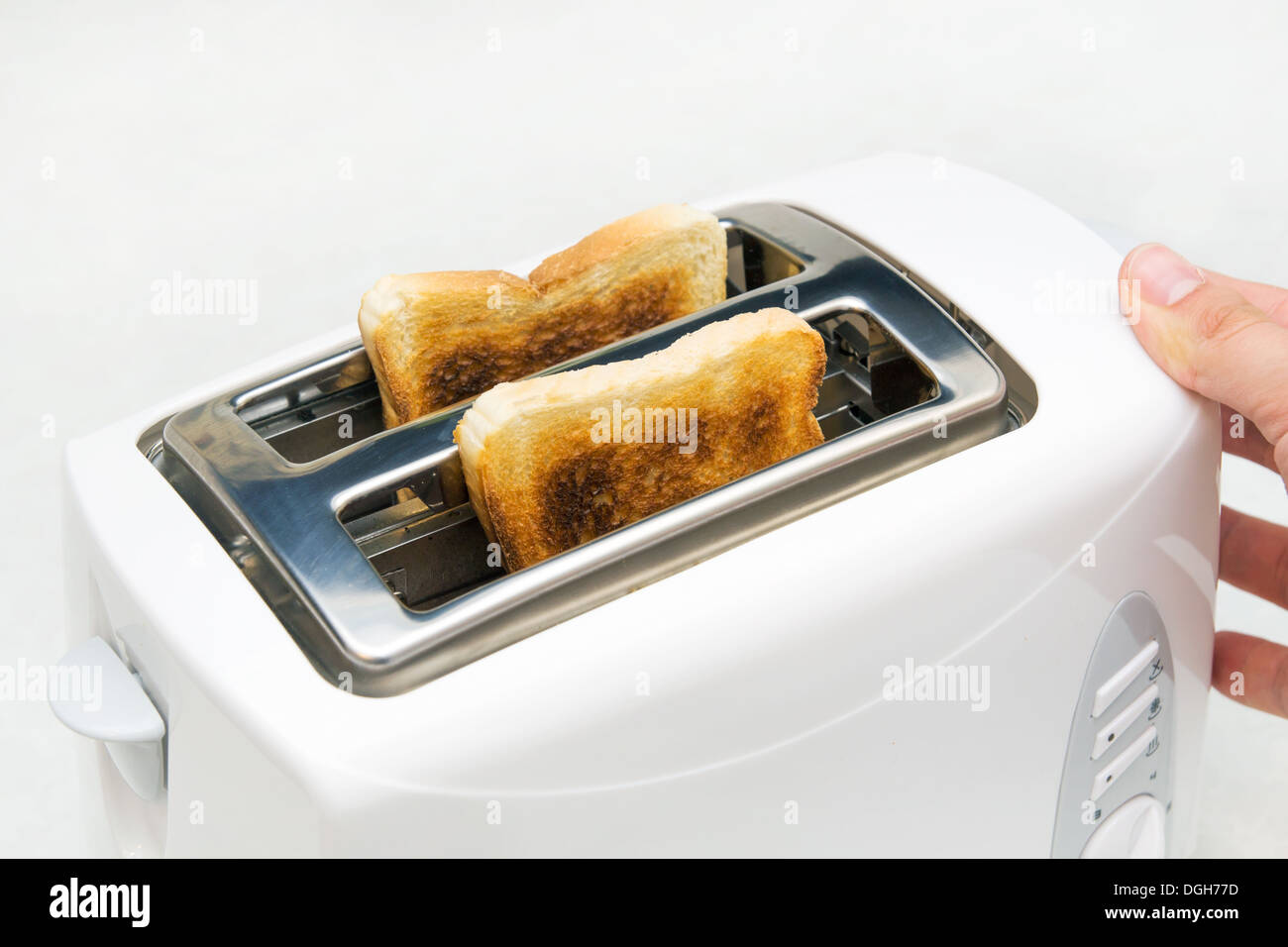 Toaster with bread slices on white background Stock Photo - Alamy