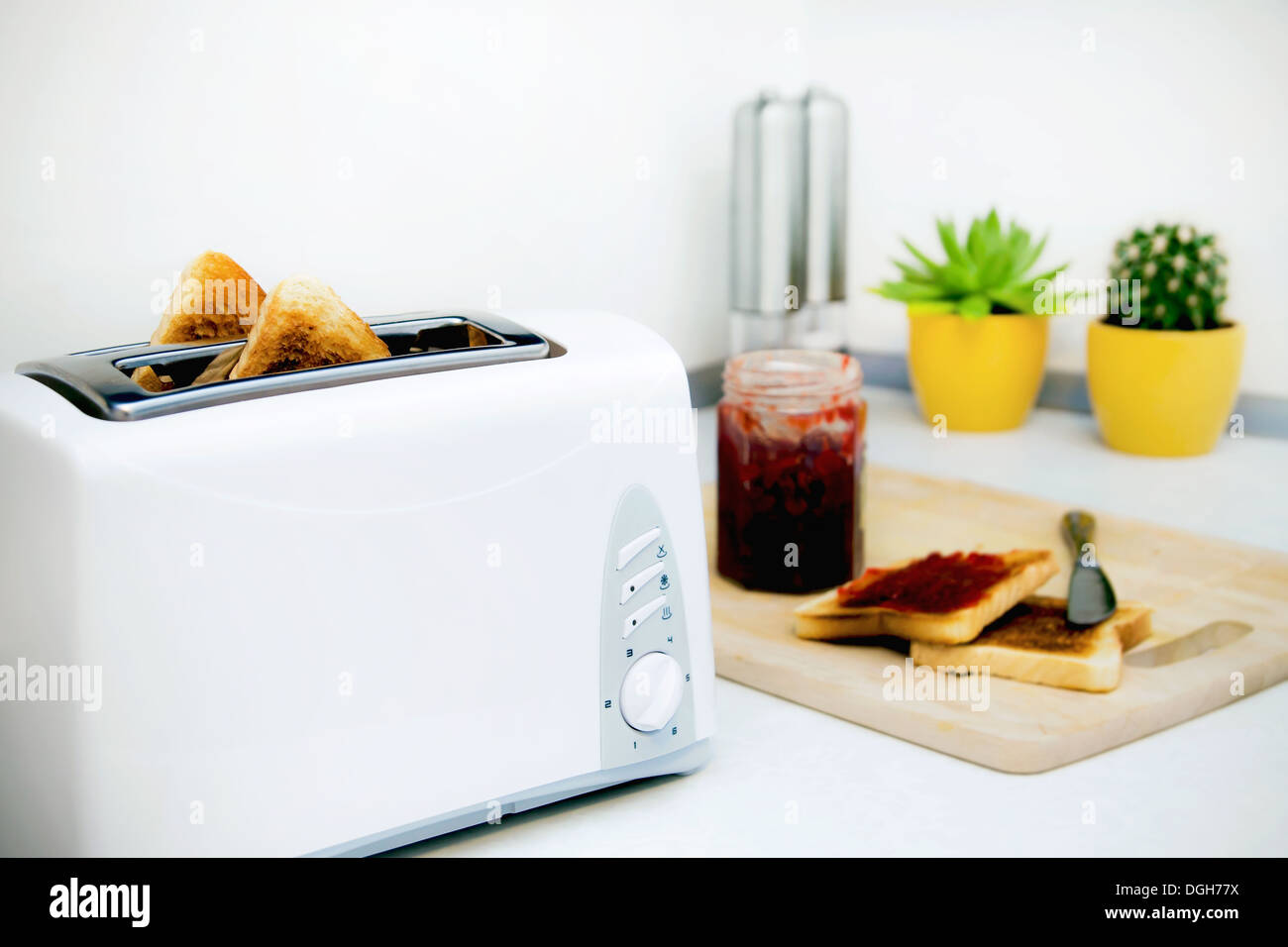 Breakfast prepare. Toaster and toast with jam in modern kitchen Stock ...