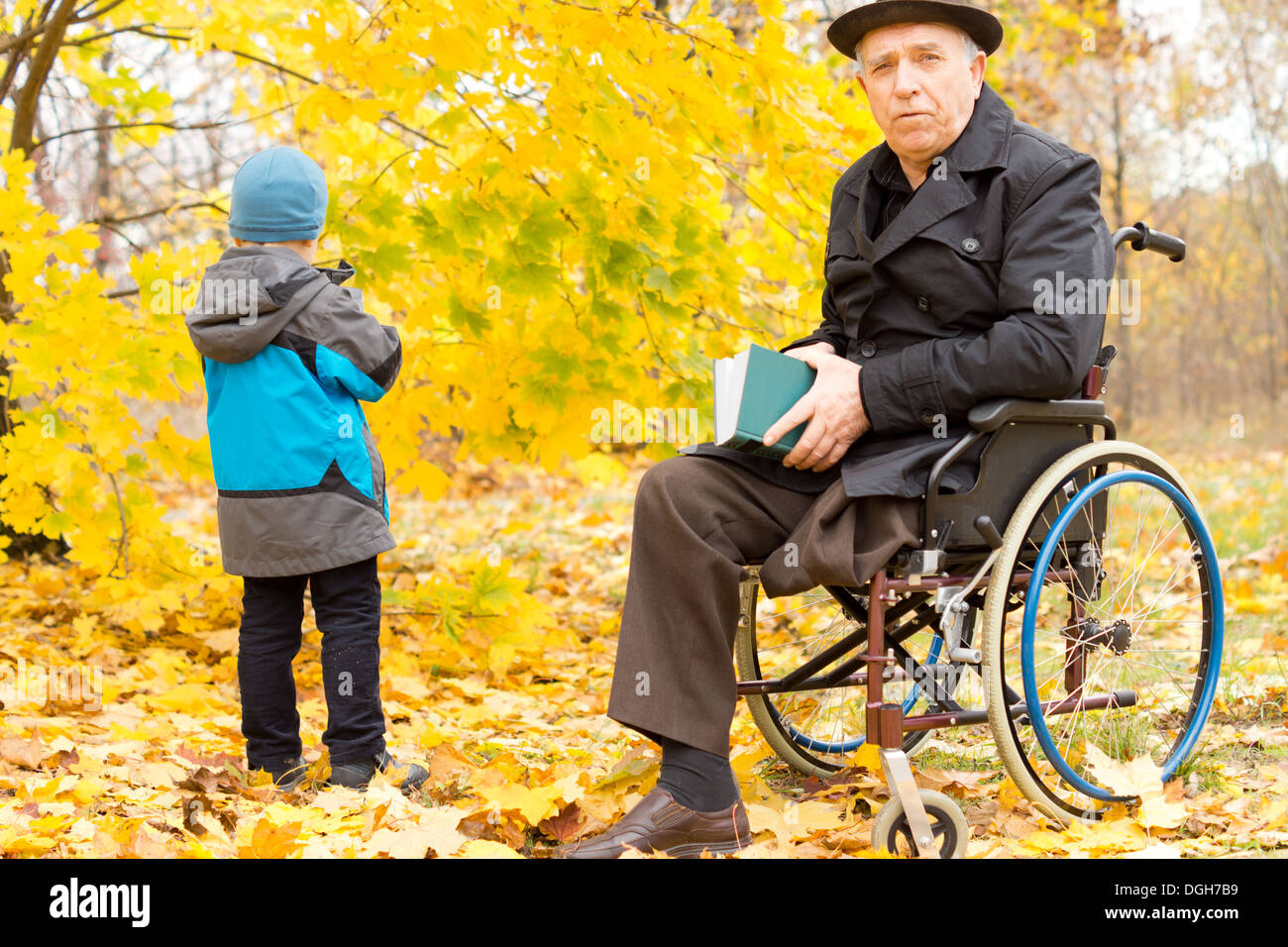 Handicapped senior man with one leg amputated accompanying a young ...