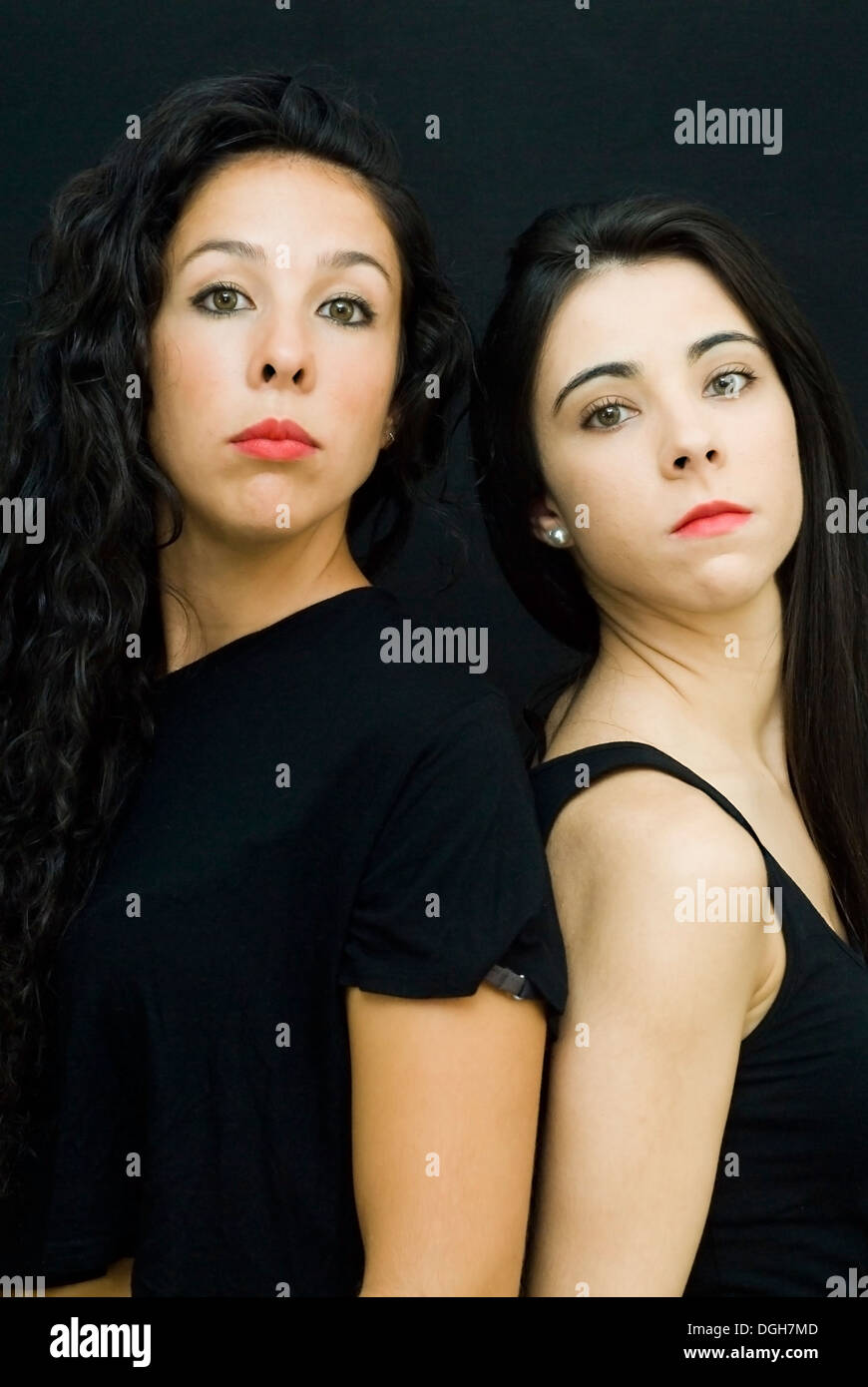 Two beautiful friends back to each other Stock Photo - Alamy
