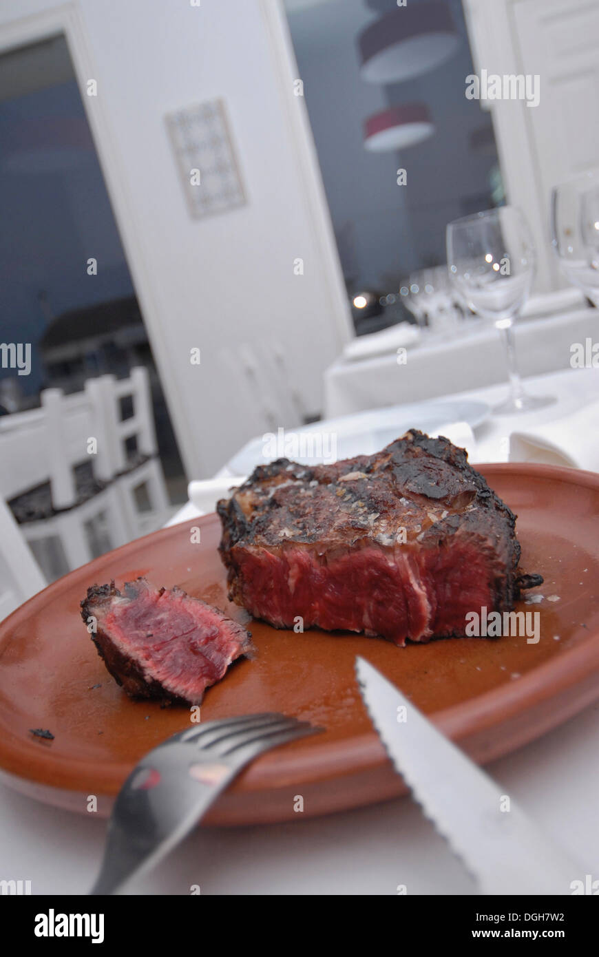 Thick beef meat cooked on a grill, at a restaurant Stock Photo - Alamy