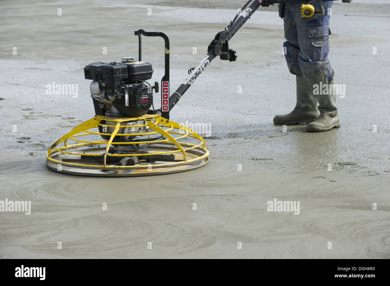 Construction work on farm building for loose housing, machine smoothing ...