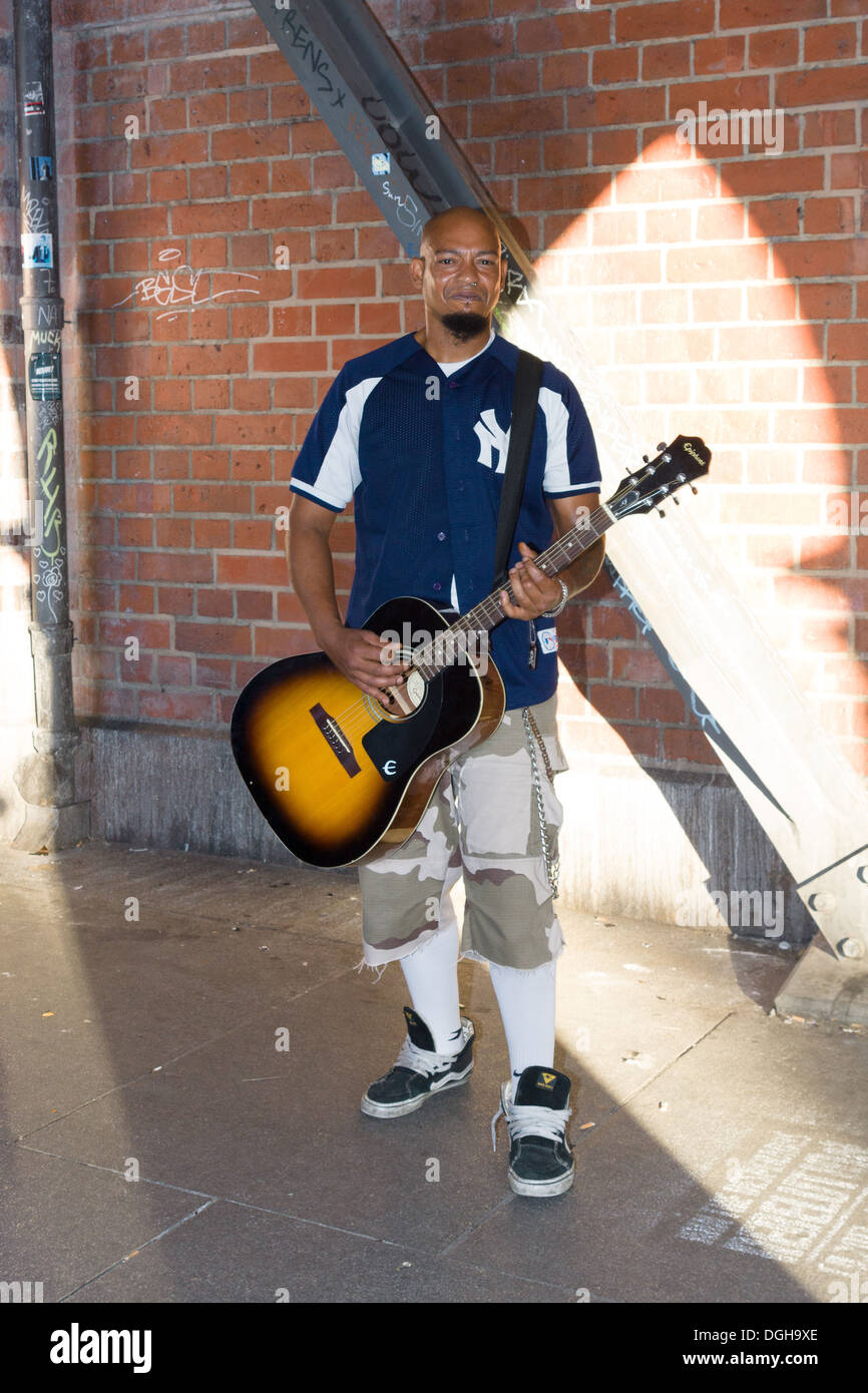 A black man, a street musician with a guitar. Berlin. Germany Stock ...