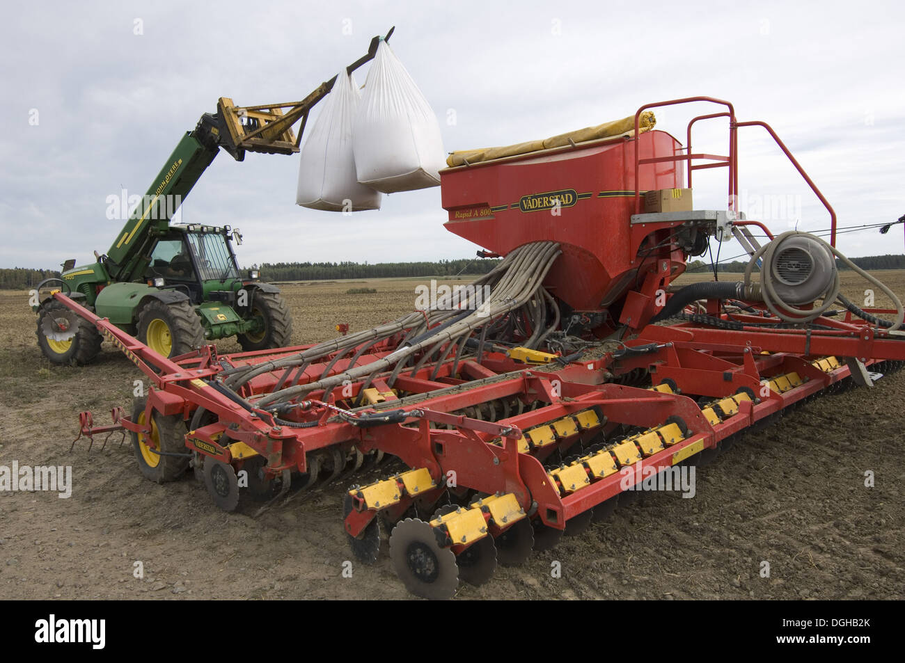 John Deere 3400 telehandler with bags of wheat seed, loading Vaderstad ...