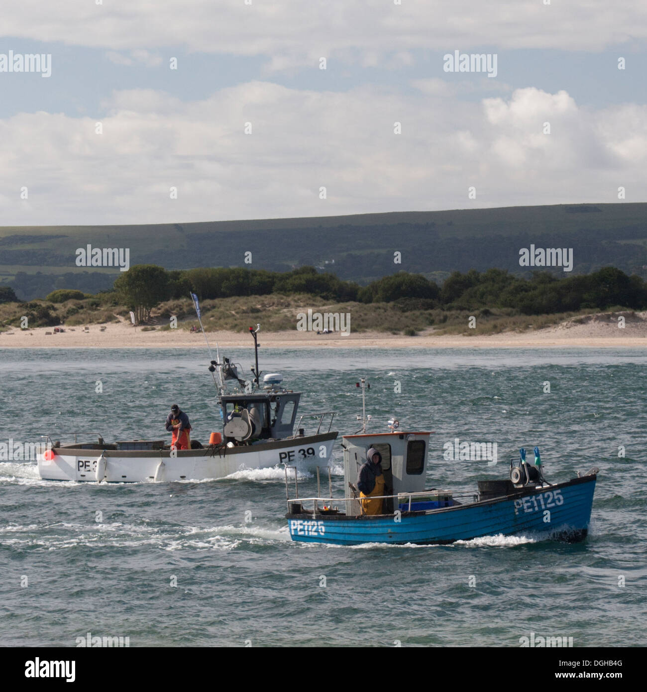 Fishing boats in Poole Harbour, UK. White boat. Blue boat. Studland ...