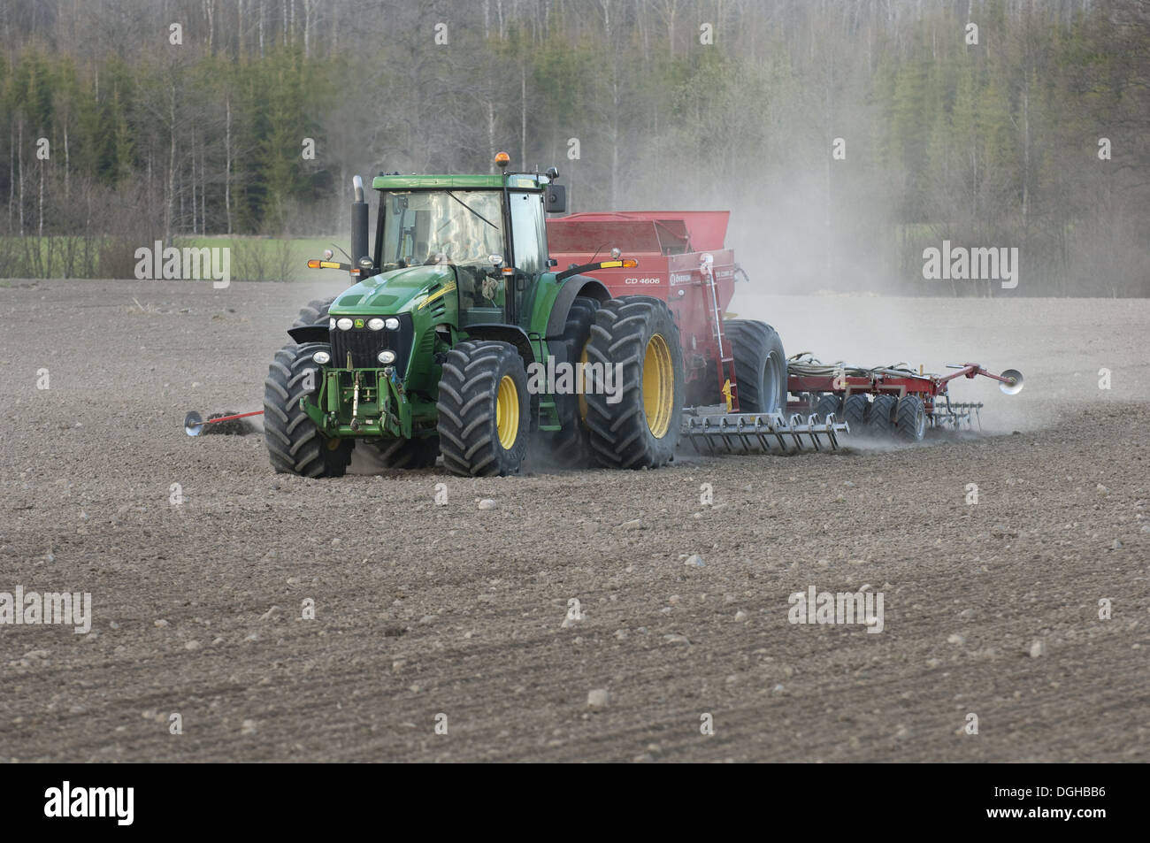 John Deere 7720 tractor with Overum seed drill, drilling arable field ...
