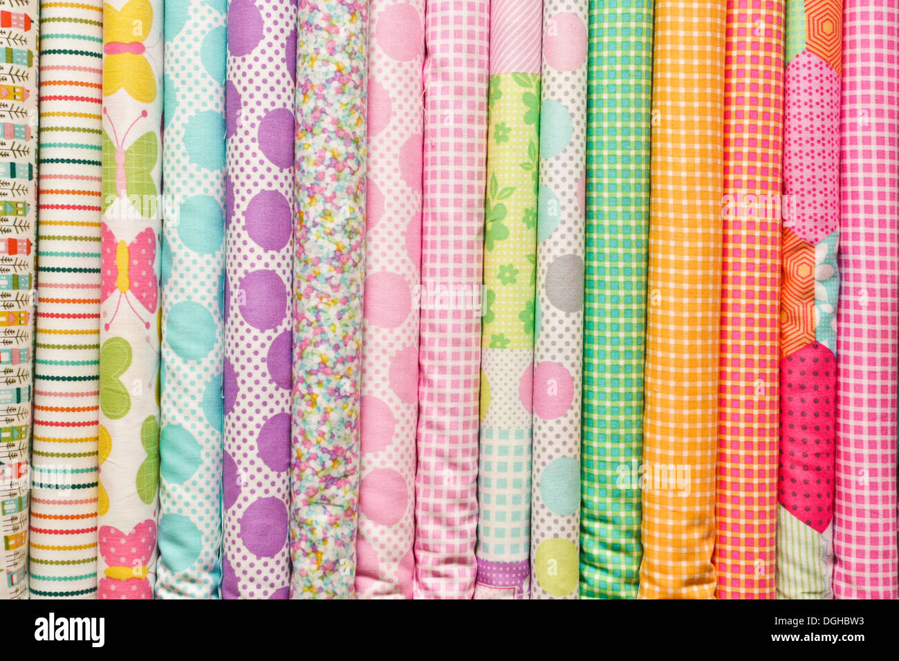 Rolls of colorful fabric as a vibrant background image Stock Photo - Alamy