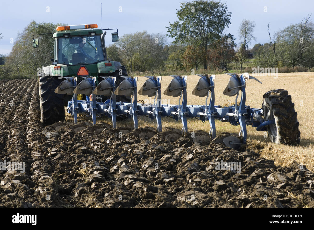 John Deere 8400 tractor pulling eight furrow reversible plough ...