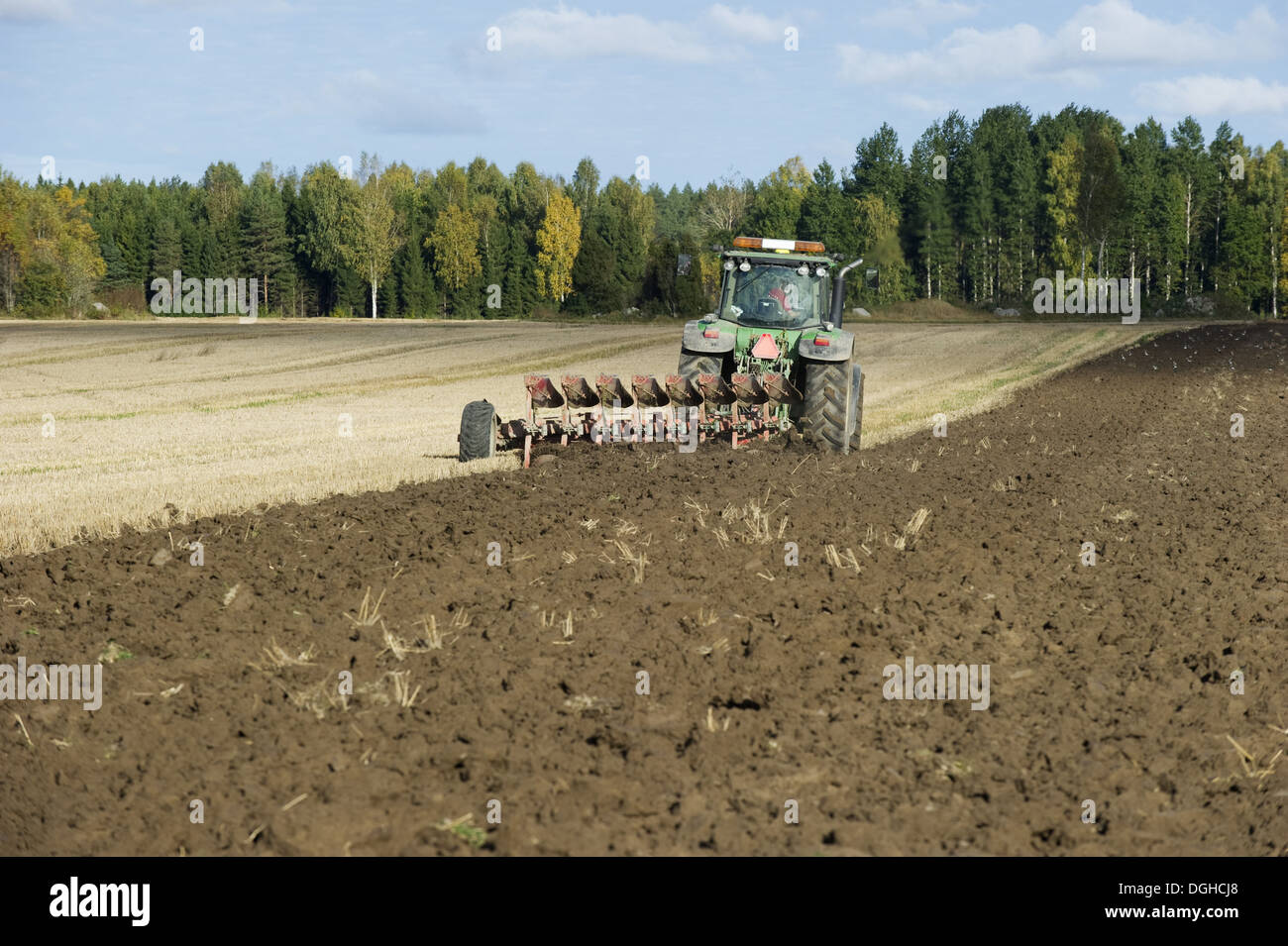 Tractor with reversible plough, ploughing arable field, Sweden ...
