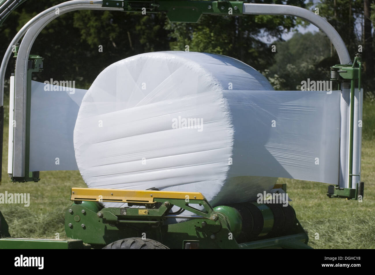Plastic wrapping round silage bale with mechanical bale-wrapper, Sweden ...