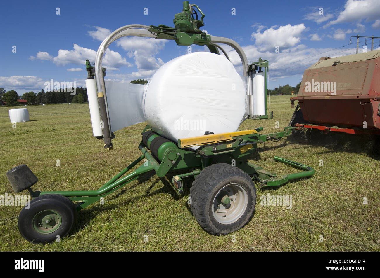 Plastic wrapped round silage bale, wrapped by mechanical bale-wrapper ...