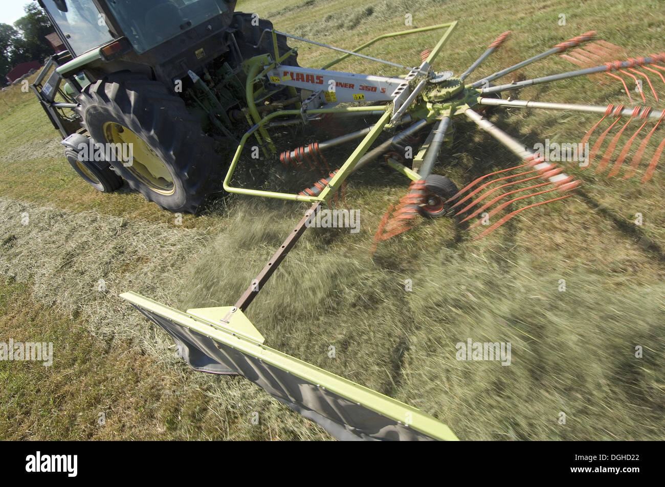 Tractor with Claas Liner 350 rotary rake, turning cut grass for silage ...