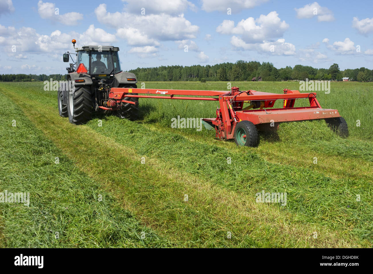 Tractor with mower, cutting grass for silage, Sweden, july Stock Photo ...