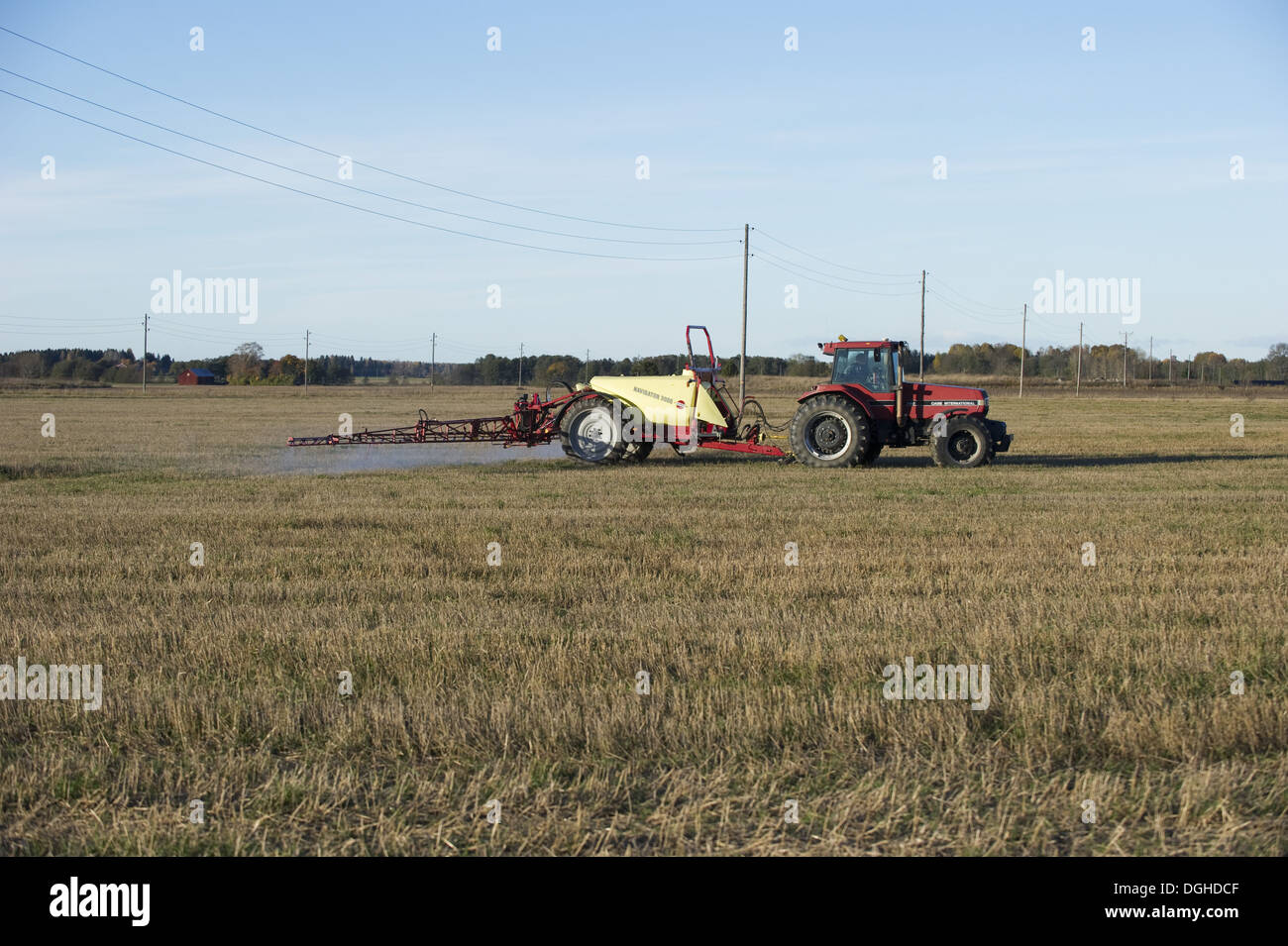Case International 7140 tractor with sprayer, spraying field with Round ...