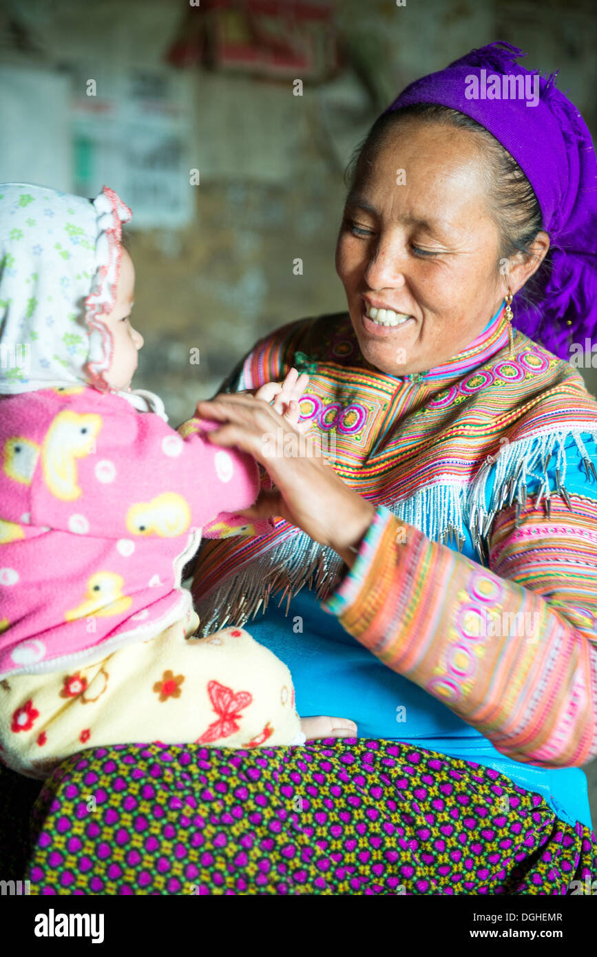 Flower Hmong woman holding the baby inside house, Bac Ha, Lao Cai Stock ...