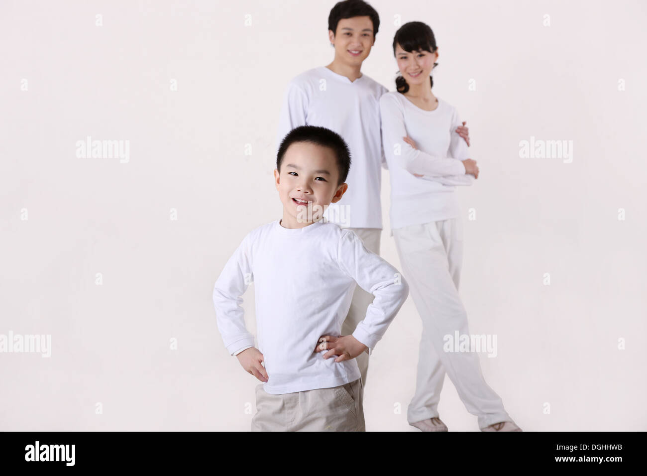 East Asian family with one child, parents standing side by side, son ...