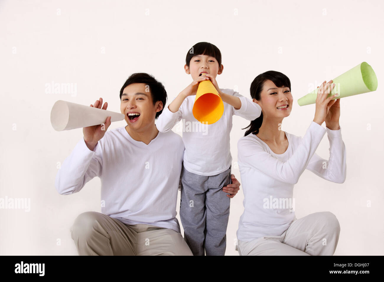 East Asian Family with One Child, Crouching and Shouting through ...
