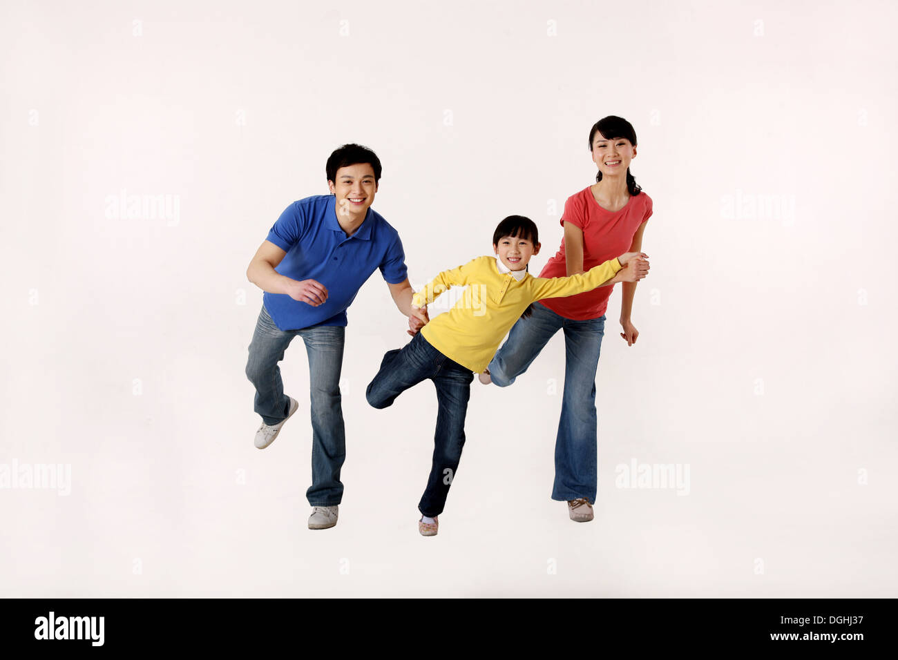 East Asian One Child Family Running Hand in Hand, Smiling, Looking at ...