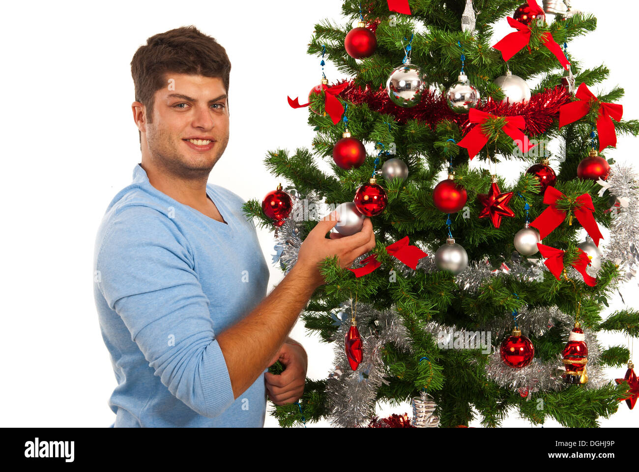 Happy man decorate Christmas tree against white background Stock Photo ...