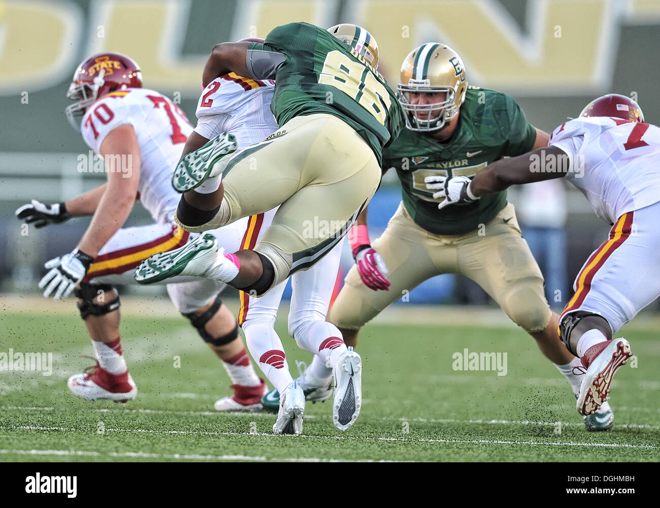 Baylor Bears defensive lineman Byron Bonds (96) jumps on top of Iowa ...