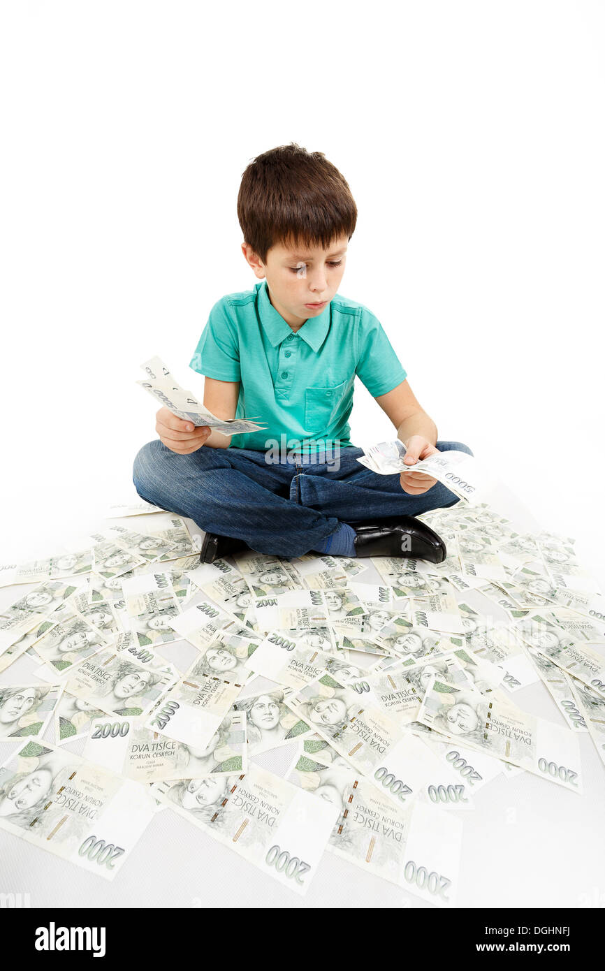 boy sitting on money, money concept, how to be successful, isolated on ...