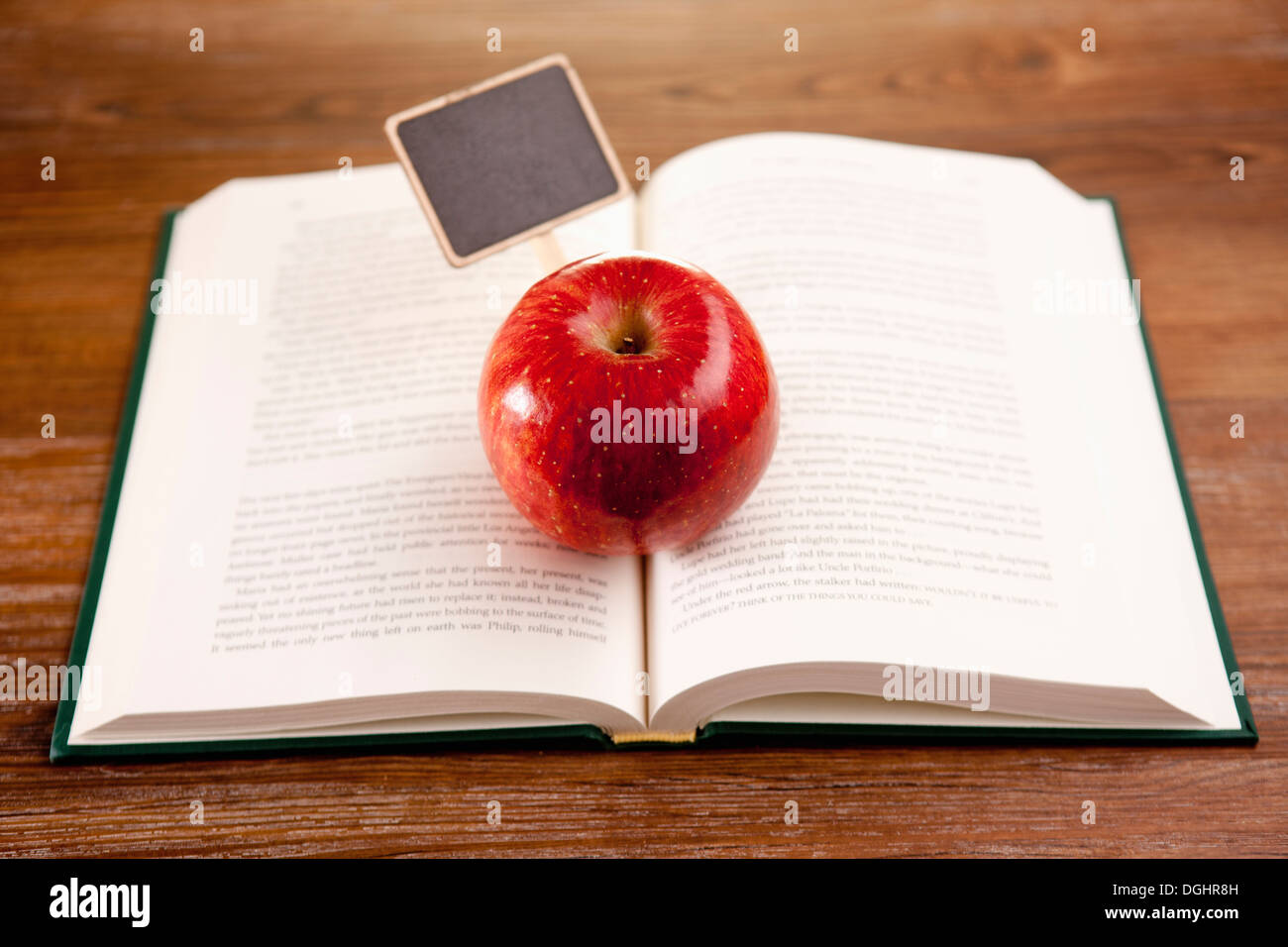 an apple on an open book Stock Photo - Alamy