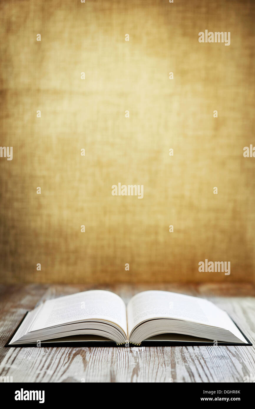 an open book lying on a table Stock Photo - Alamy