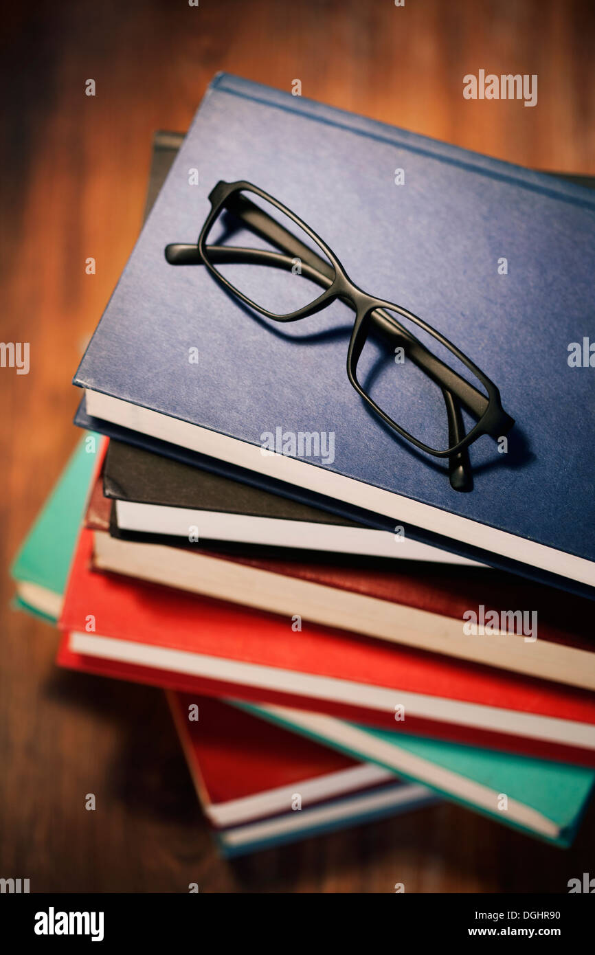 several different color books in a pile Stock Photo - Alamy