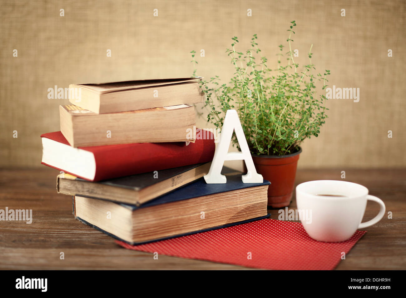 old looking books in a pile next to a plant Stock Photo - Alamy