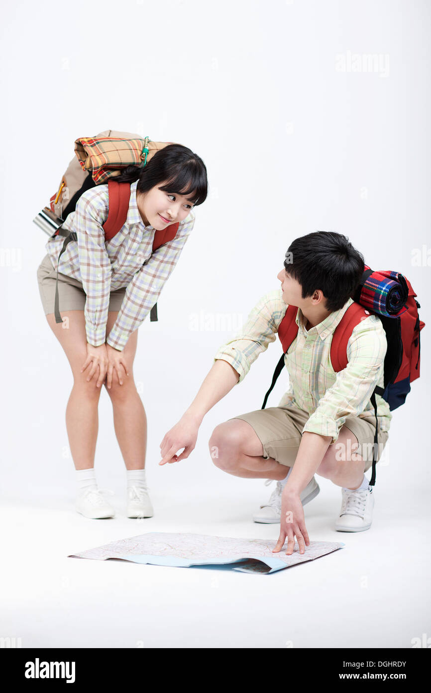 Hiker couple looking map pointing hi-res stock photography and images ...