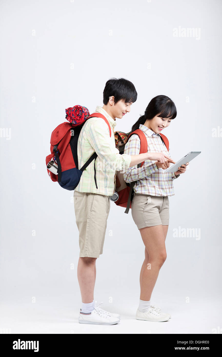a hiker couple looking at a map Stock Photo - Alamy